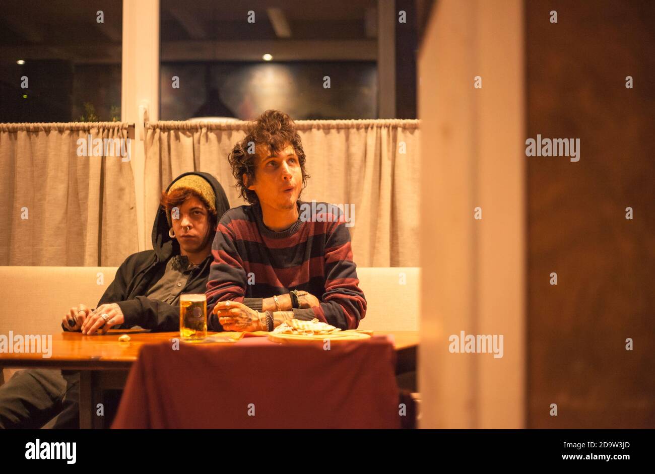 Two kids eat at fast food sitted at table Stock Photo - Alamy