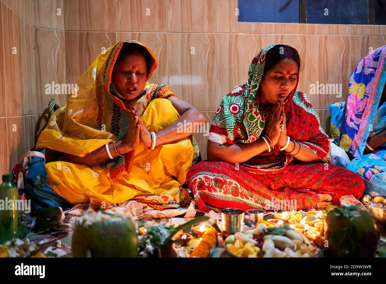 Thousands of Hindu devotees sit with Prodip and pray to God in front of ...