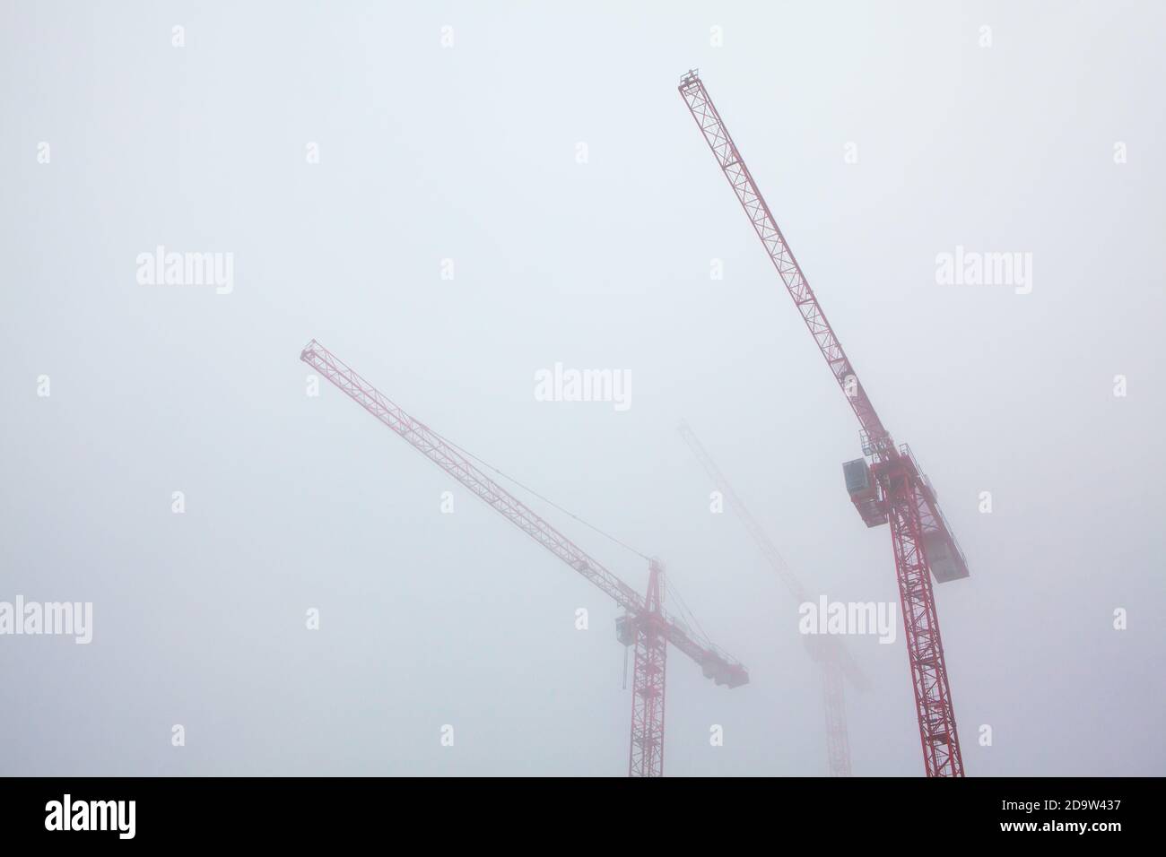 Industrial cranes in the foggy morning . Modern construction site Stock ...
