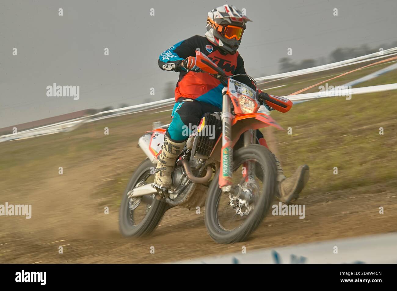 Motocross rider intent on driving his motorbike to the finish line in a ...