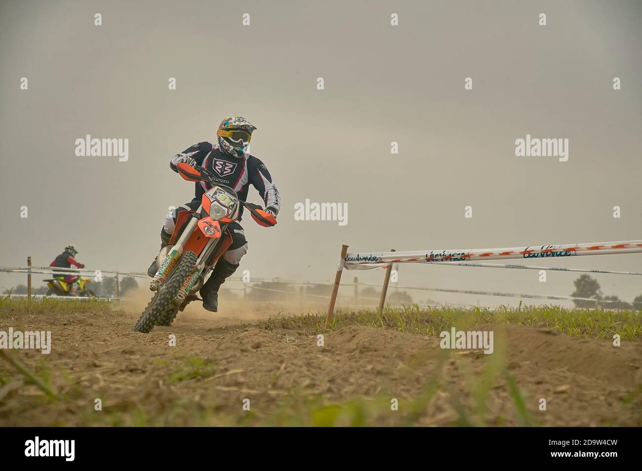 Motocross rider intent on driving his motorbike to the finish line in a ...