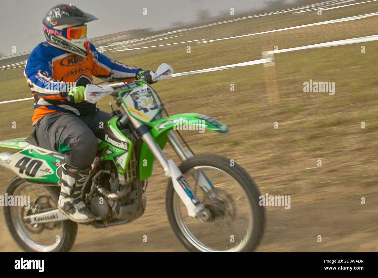 Motocross rider intent on driving his motorbike to the finish line in a ...