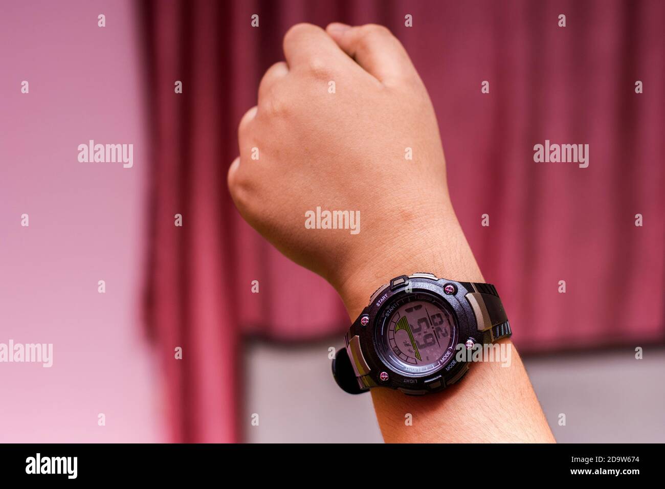 Black wrist watch with bach band on a kids hand Stock Photo - Alamy