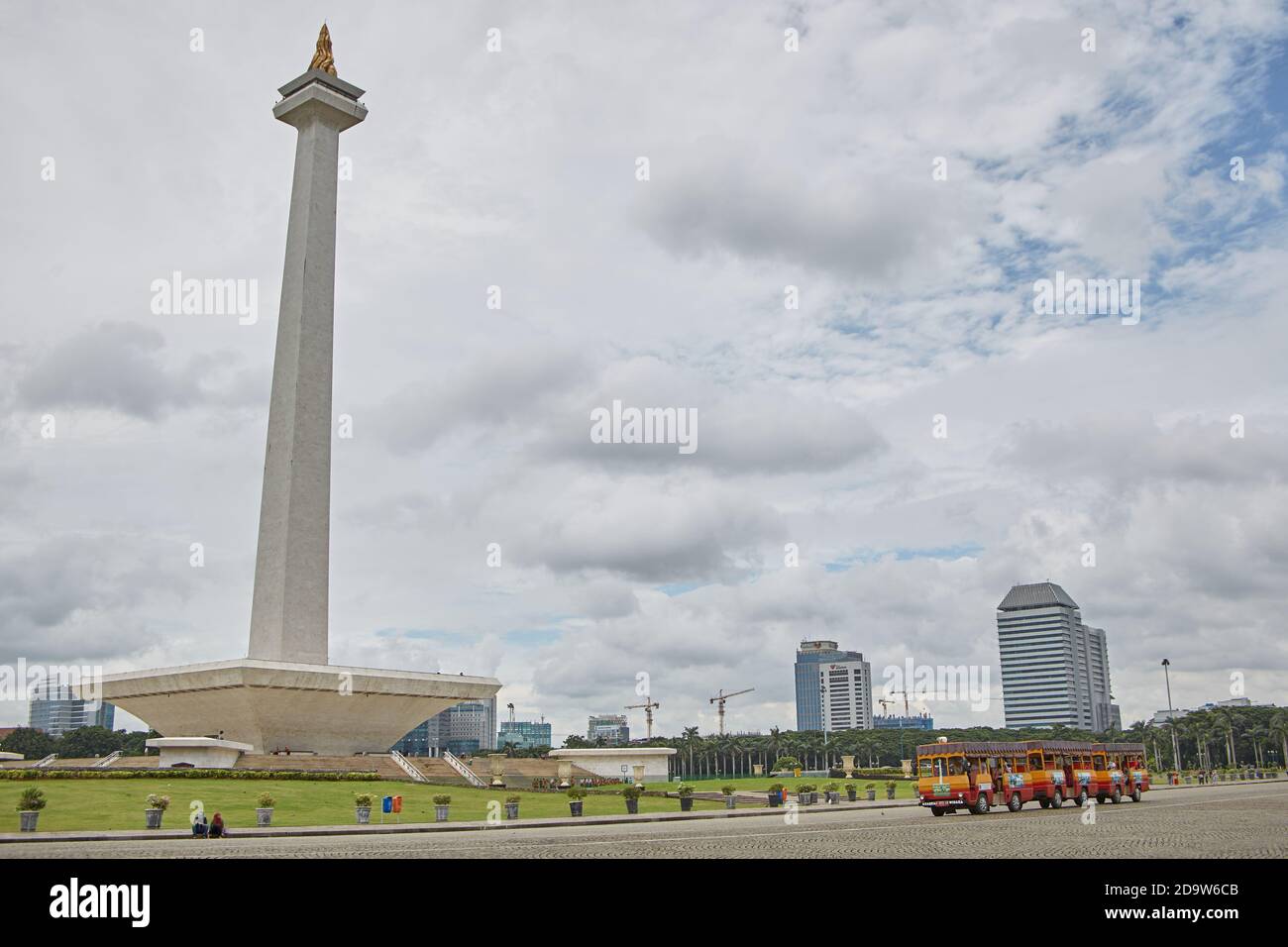 Jakarta, Indonesia, March 2016. A bus in front of the obelisk ...