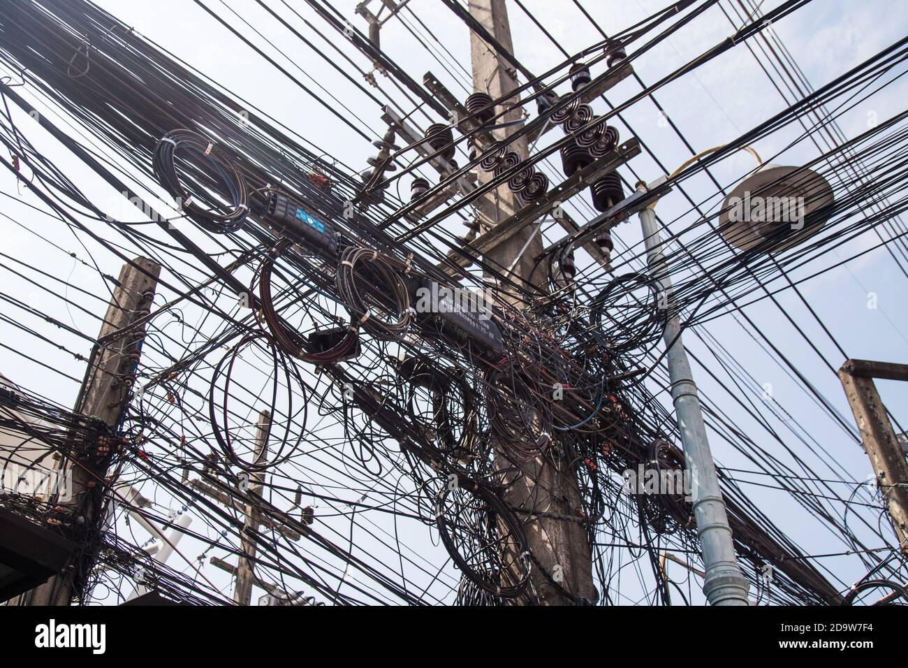 Messy entangled electricity, telecommunication wires, cables in under ...