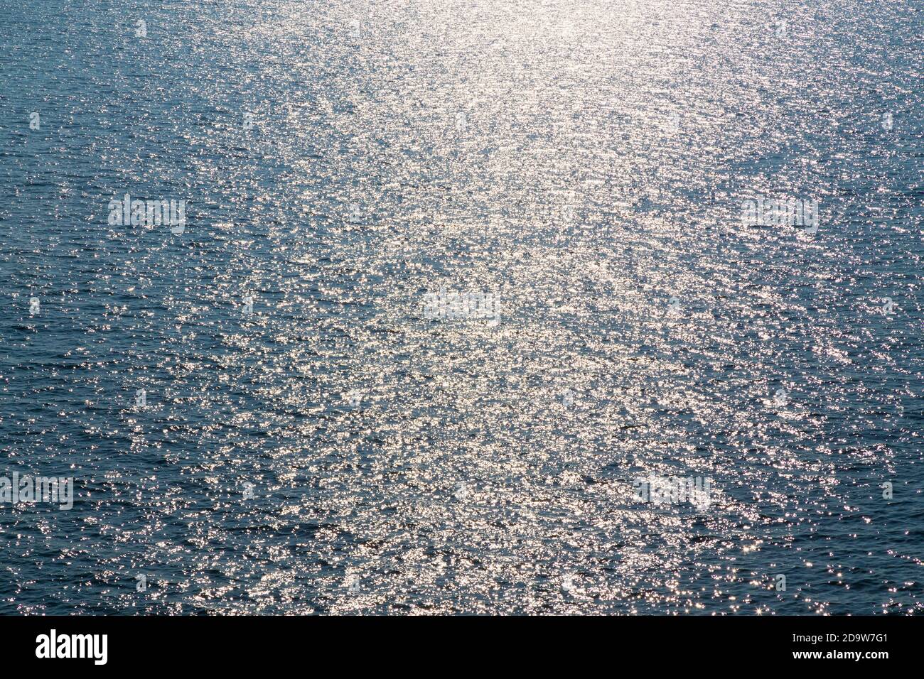 Blue ocean sea with glowing sky reflection as background Stock Photo ...