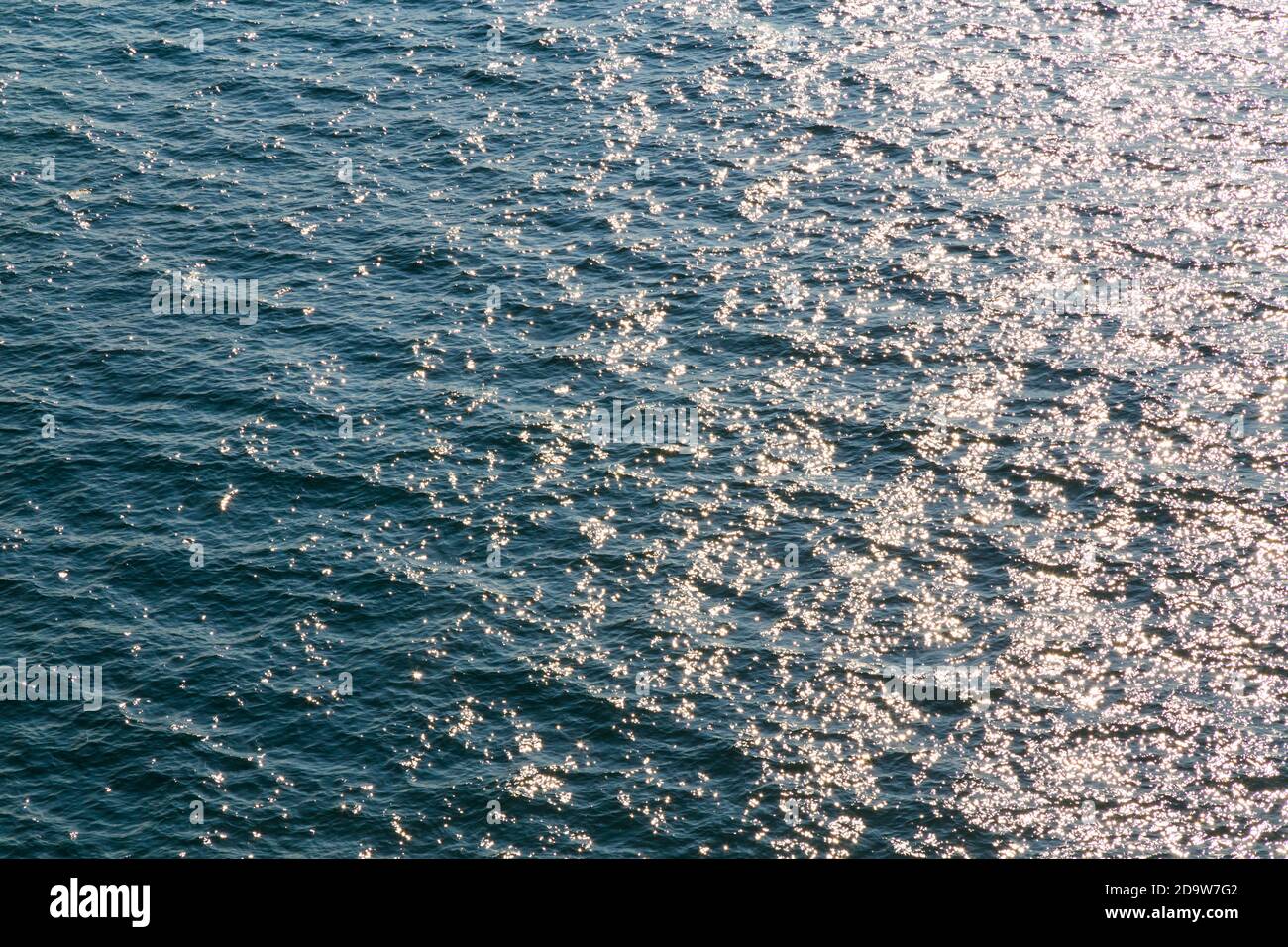 Blue ocean sea with glowing sky reflection as background Stock Photo ...