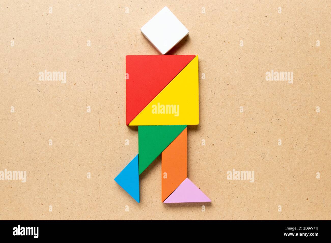 Color tangram puzzle in walking man shape on wood background Stock ...