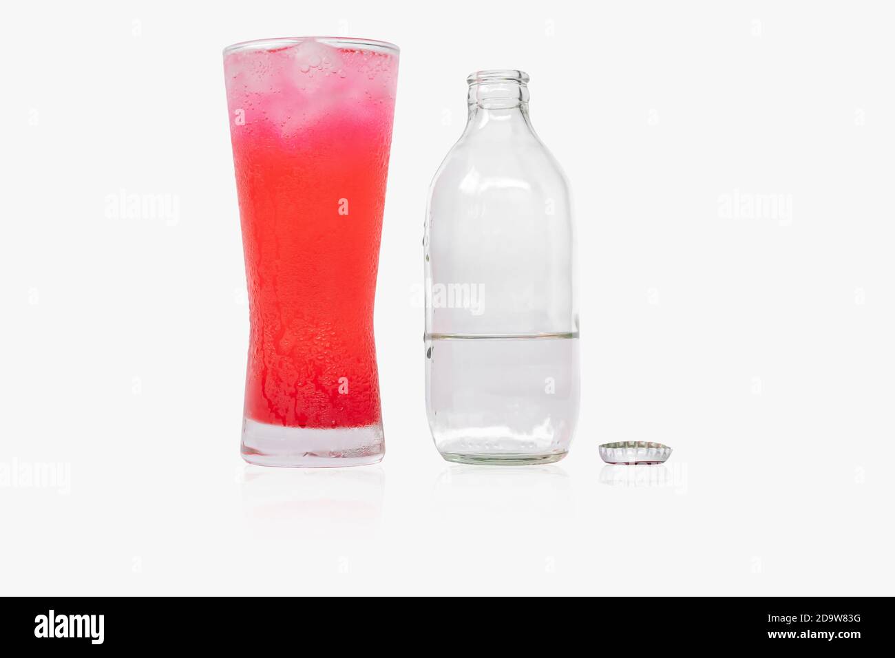 Glass of red nectar mixed with soda and soda bottles that open the lid ...