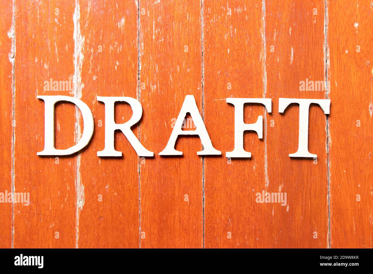 Alphabet letter in word draft on old red color wood plate background ...