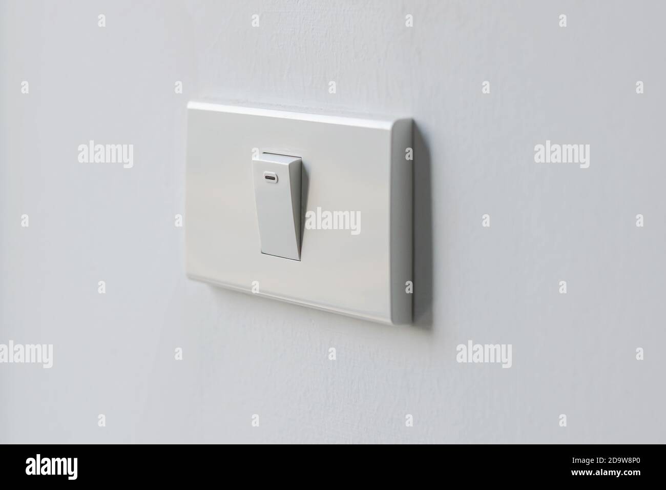Closeup a white switch for on and off wall lighting for office and ...