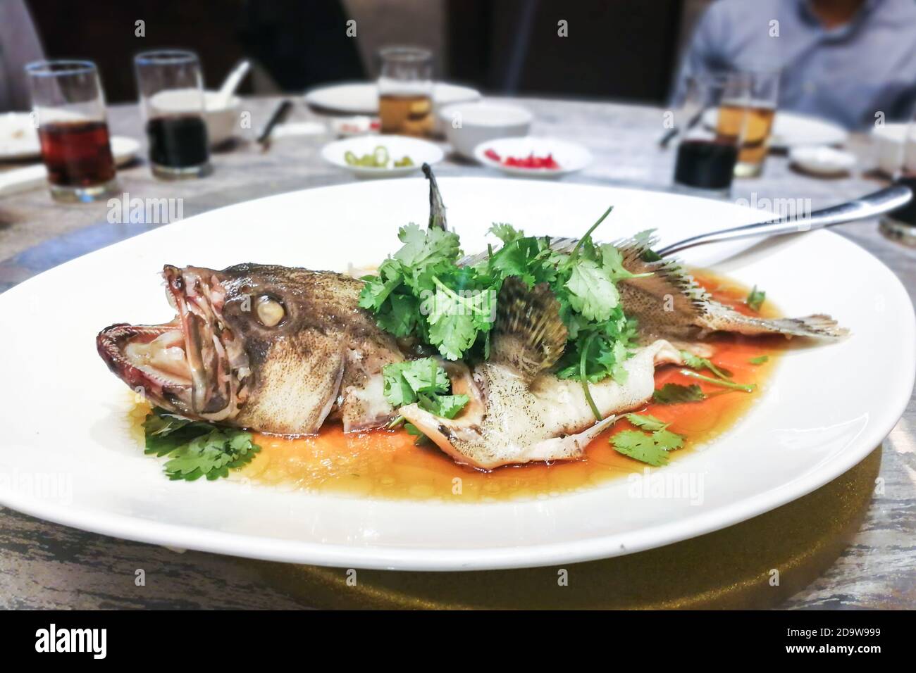 Serving of steamed grouper fish Chinese style during festive ...