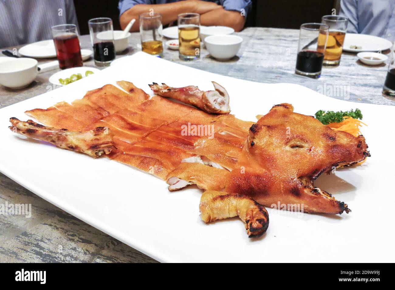 Serving of delicious suckling pig in restaurant during celebration ...