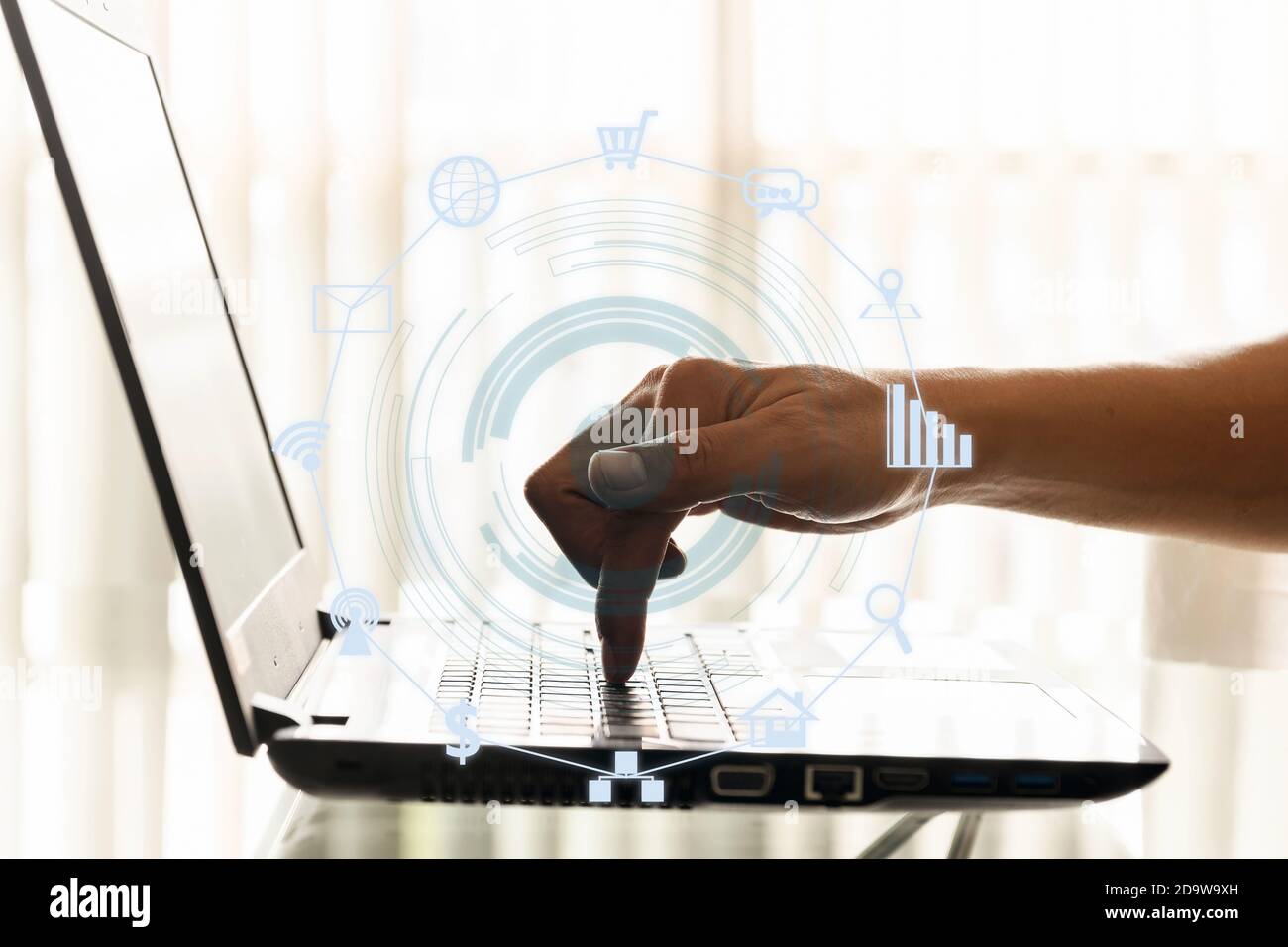 A businessman's finger is pressing down on the laptop's keyboard button ...