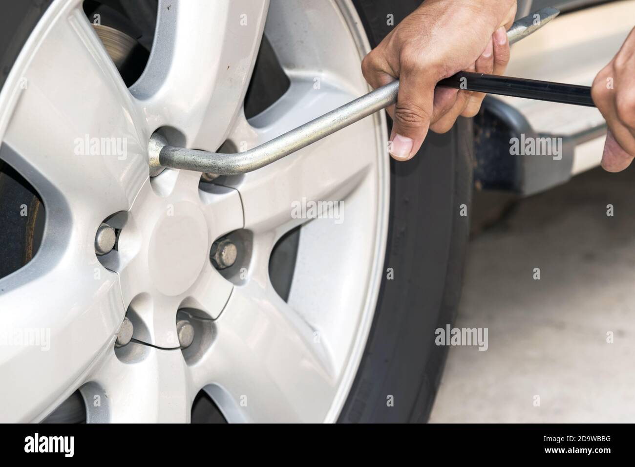 Removing the wheel nut with a wrench Stock Photo - Alamy