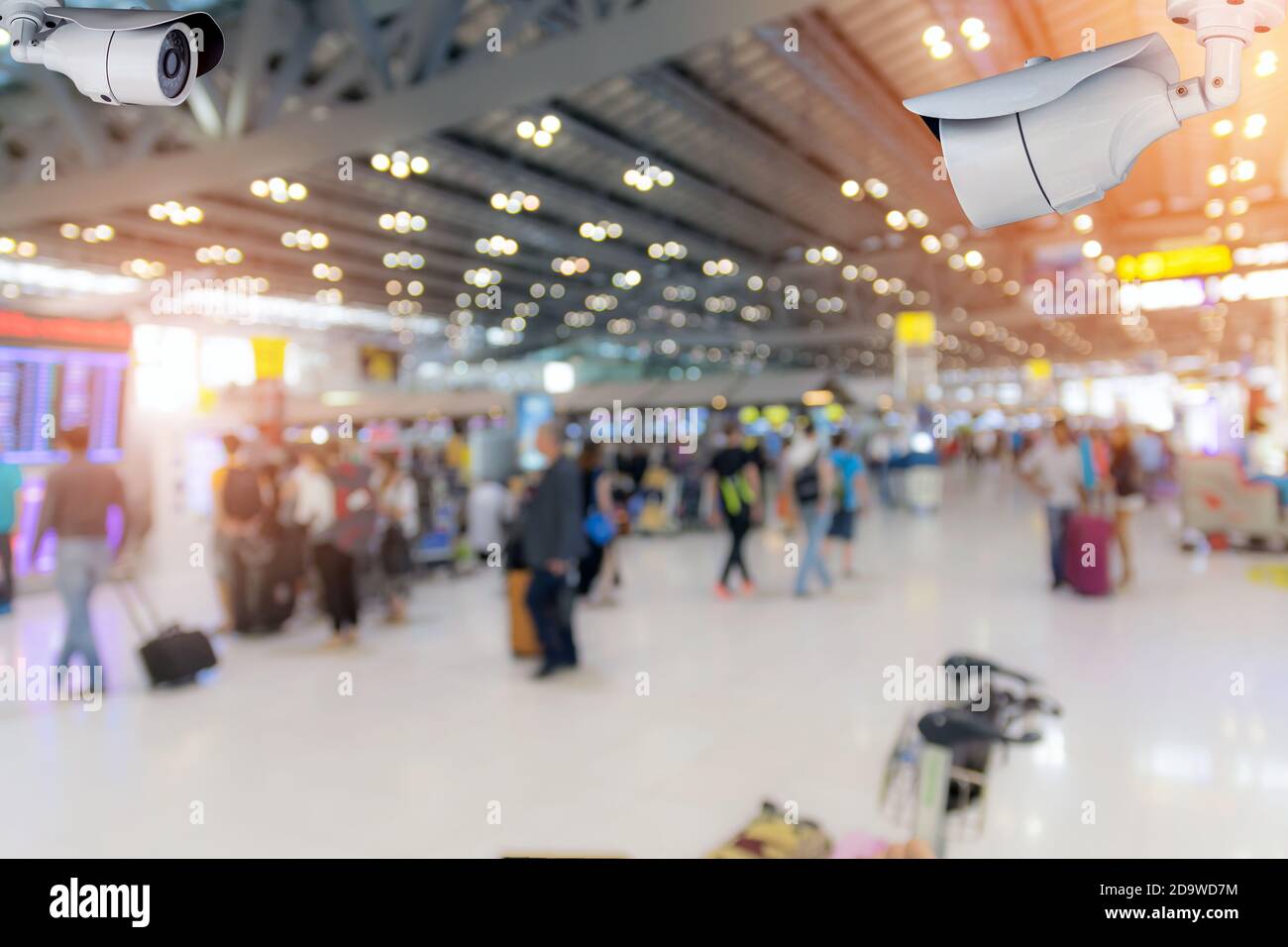 Closeup CCTV security camera on blurred inside the airport terminal ...