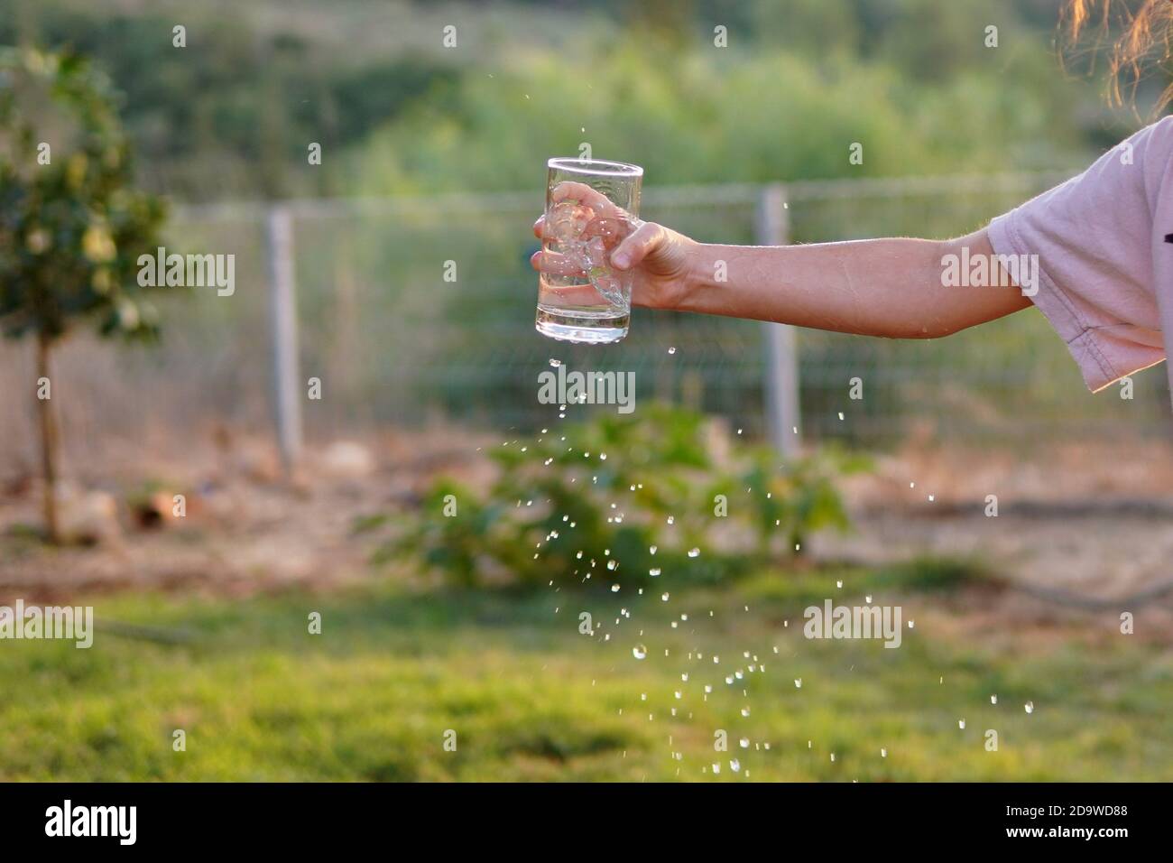 girl spilling water from glass Stock Photo - Alamy
