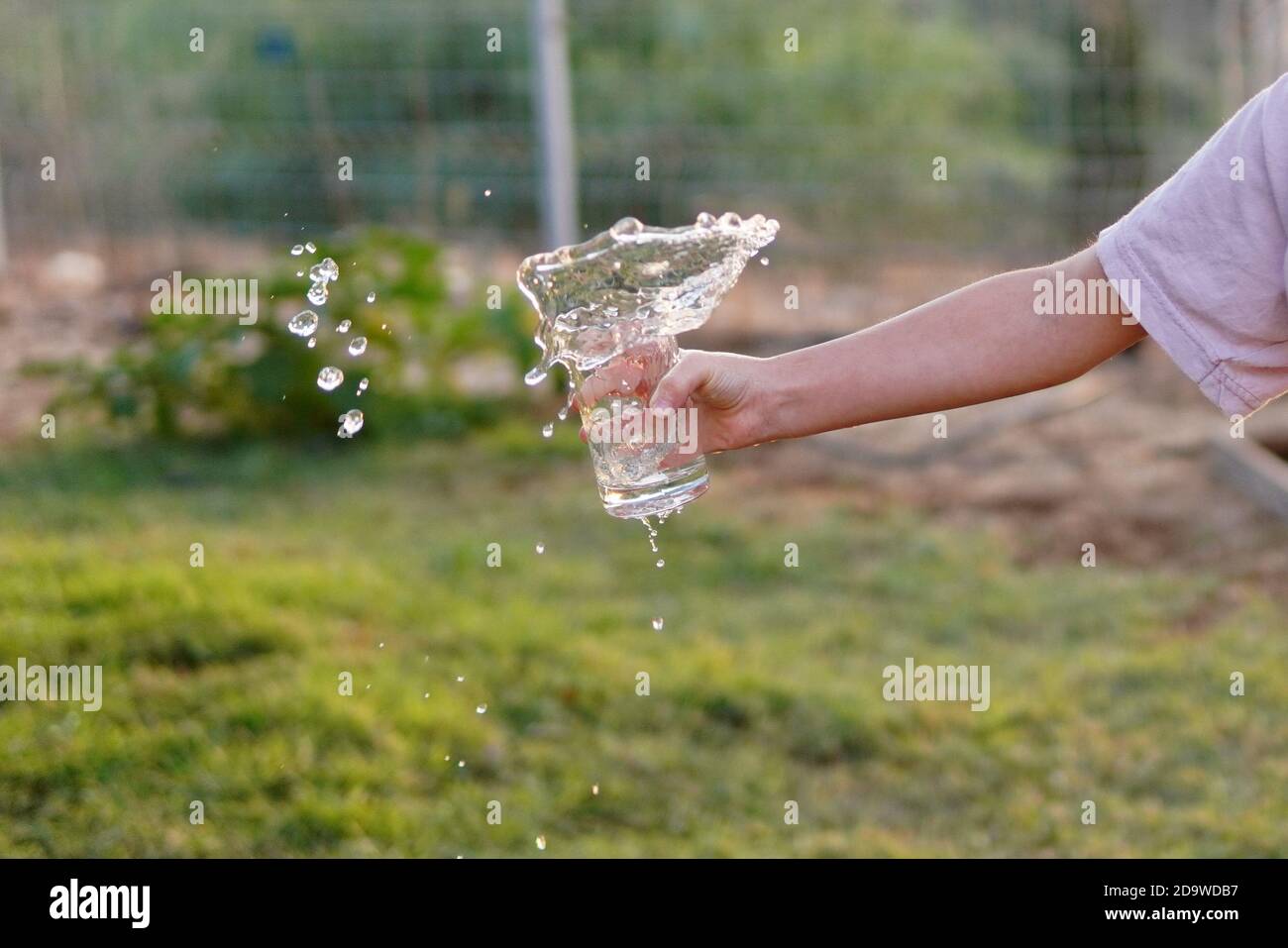 girl spilling water from glass Stock Photo - Alamy