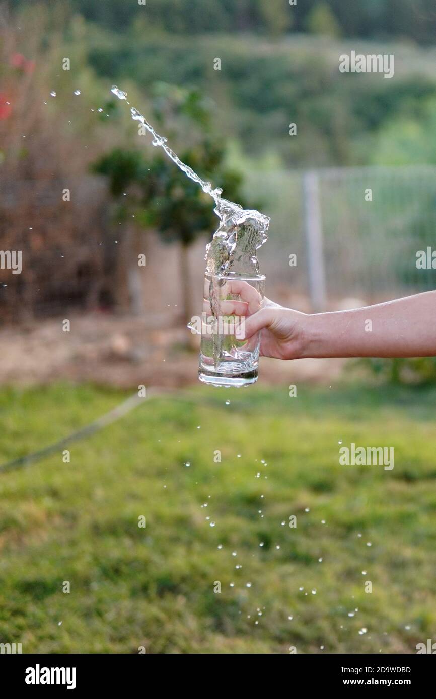 girl spilling water from glass Stock Photo - Alamy