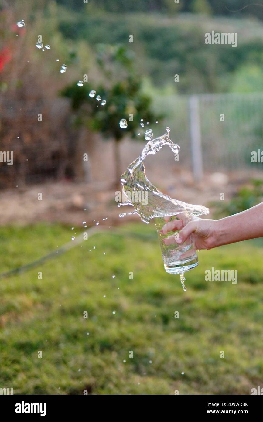 girl spilling water from glass Stock Photo - Alamy