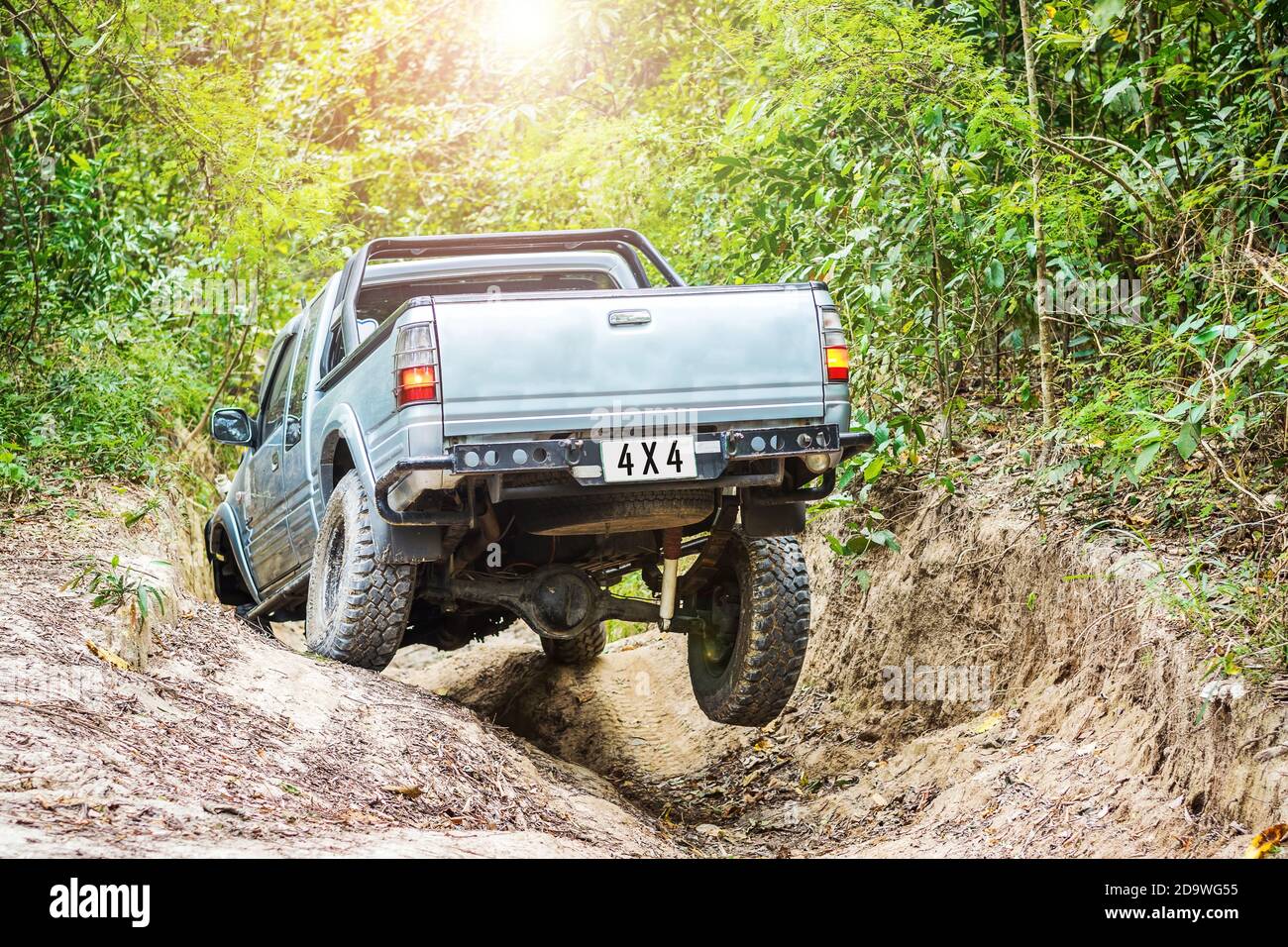 4 wheel drive is climbing on a difficult off-road in mountain forests ...