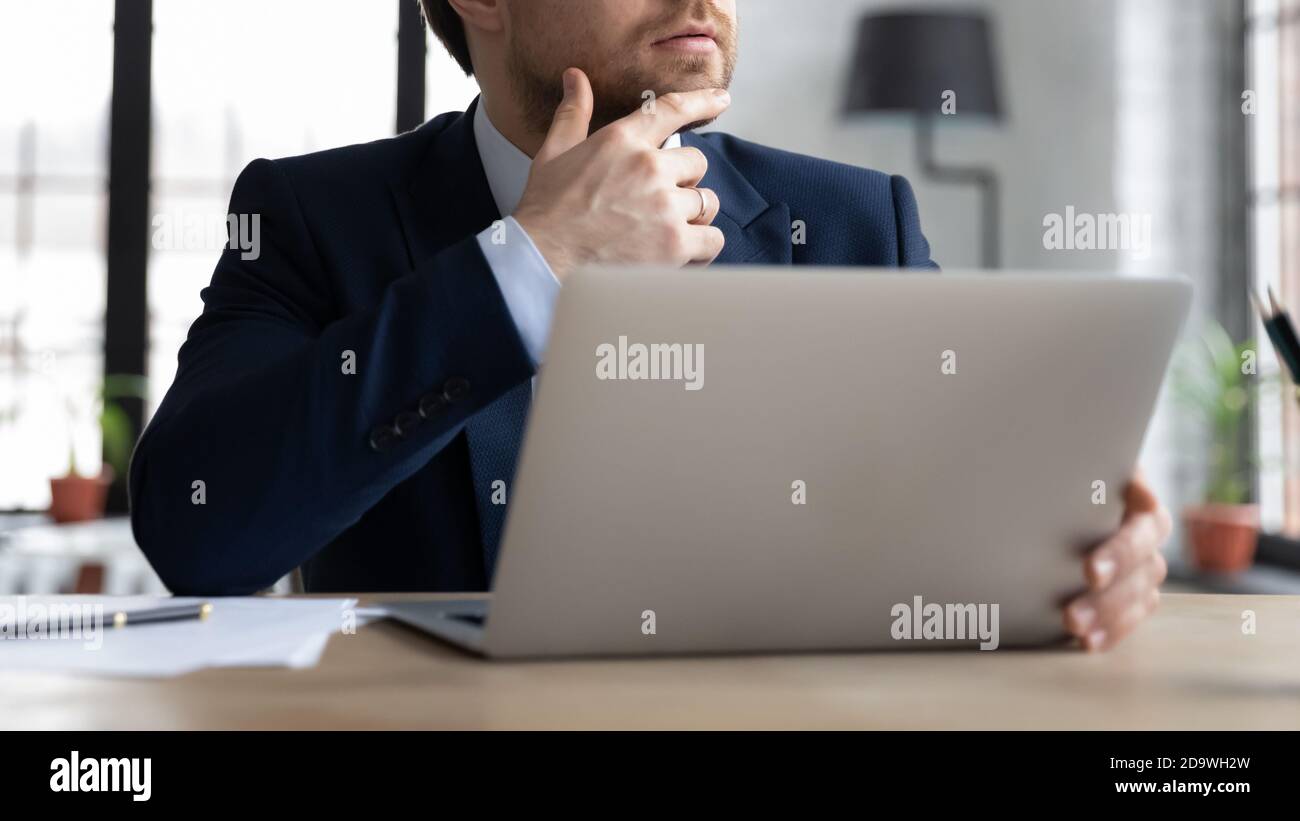 Close up pensive male ceo manager touching chin Stock Photo - Alamy