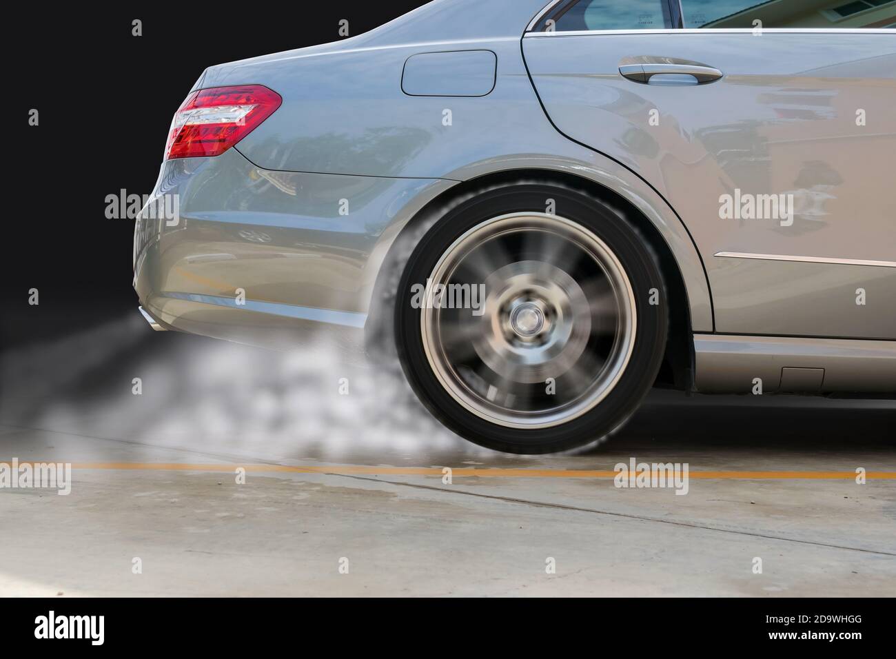 Closeup of the rear wheel of a car that spin and cause smoke Stock ...