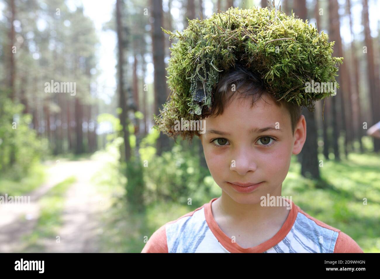 Child with moss on his head in pine forest Stock Photo - Alamy