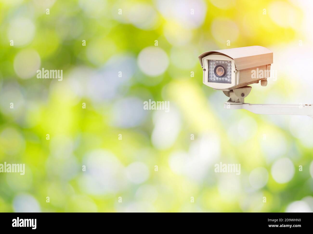 Closeup CCTV or surveillance camera in the garden with colorful green ...