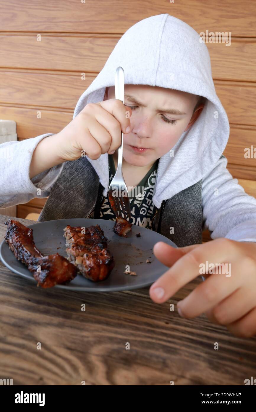 Child eating pork meat hi-res stock photography and images - Alamy
