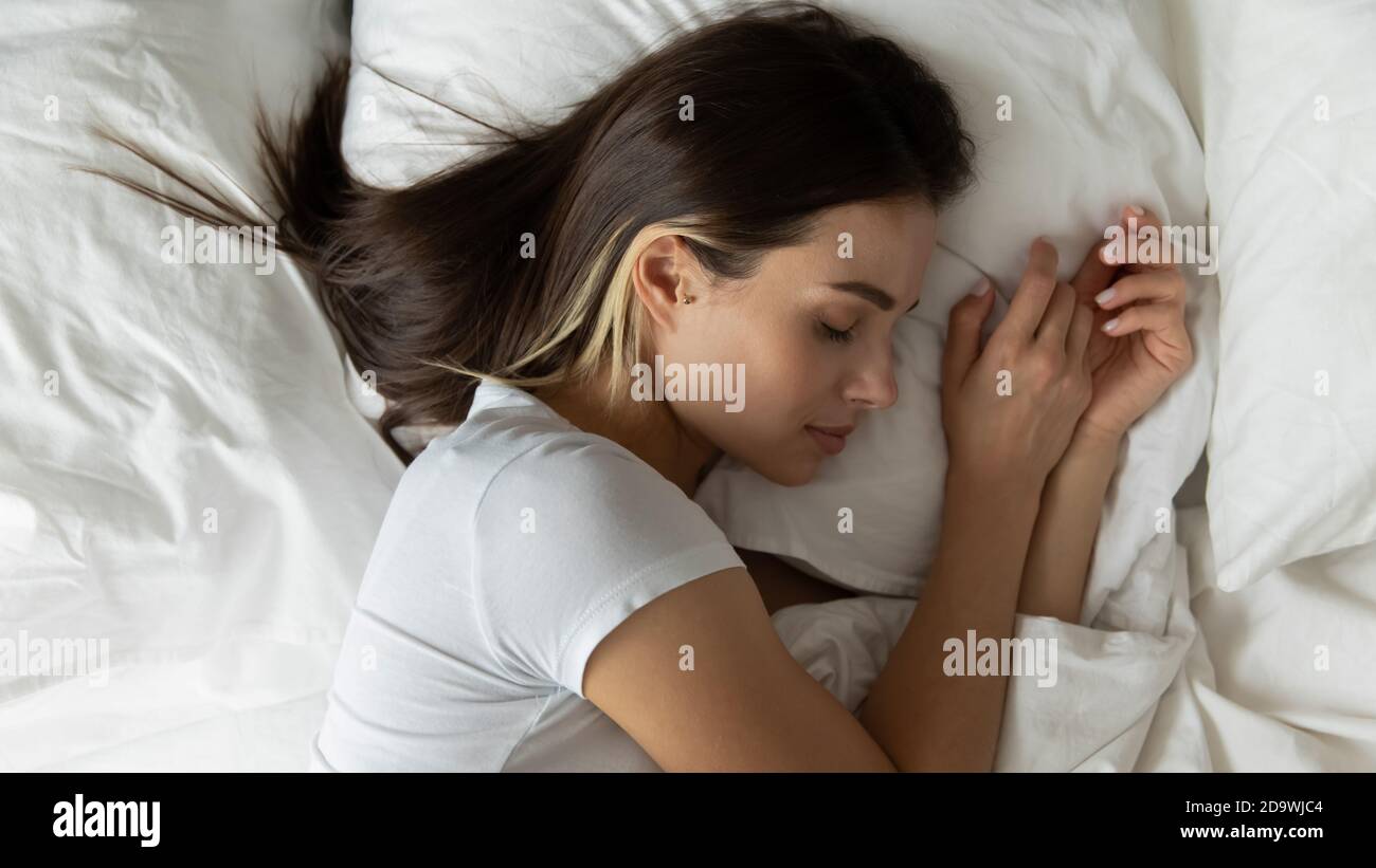 Charming teenage girl napping in soft bed enjoying peace serenity Stock ...