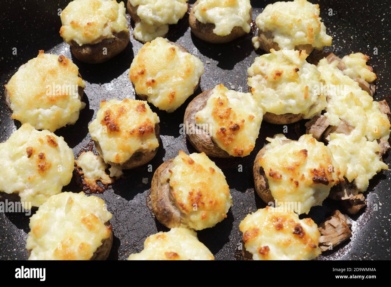 Baked champignons with cheese in a pan Stock Photo - Alamy