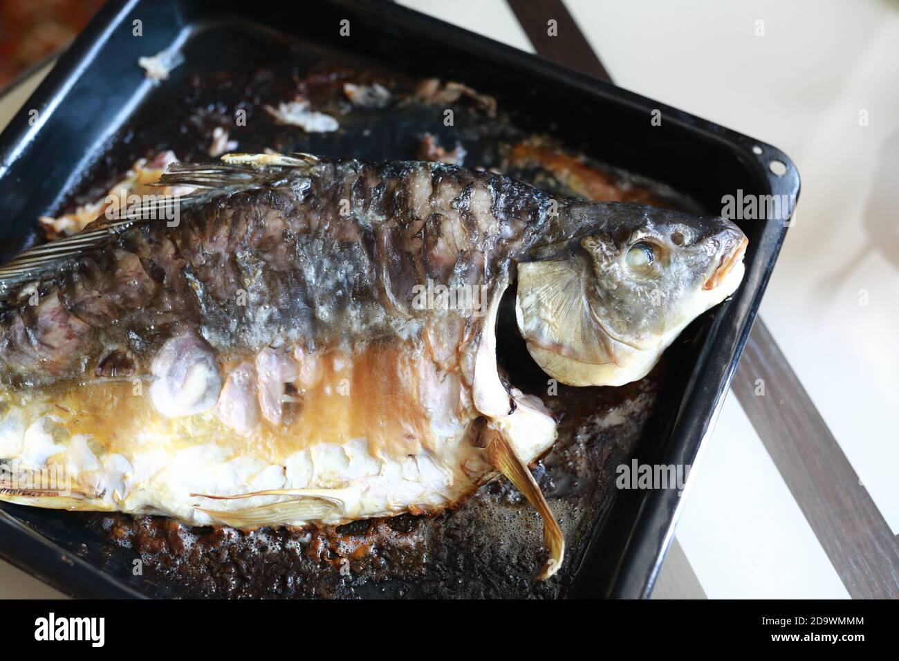 Oven baked carp on a baking sheet Stock Photo - Alamy