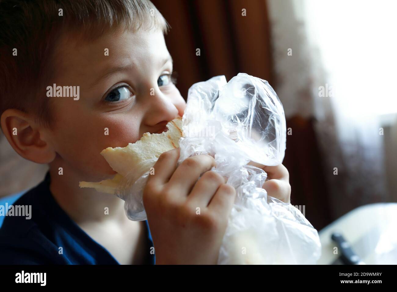Child eating pie in kitchen at home Stock Photo - Alamy