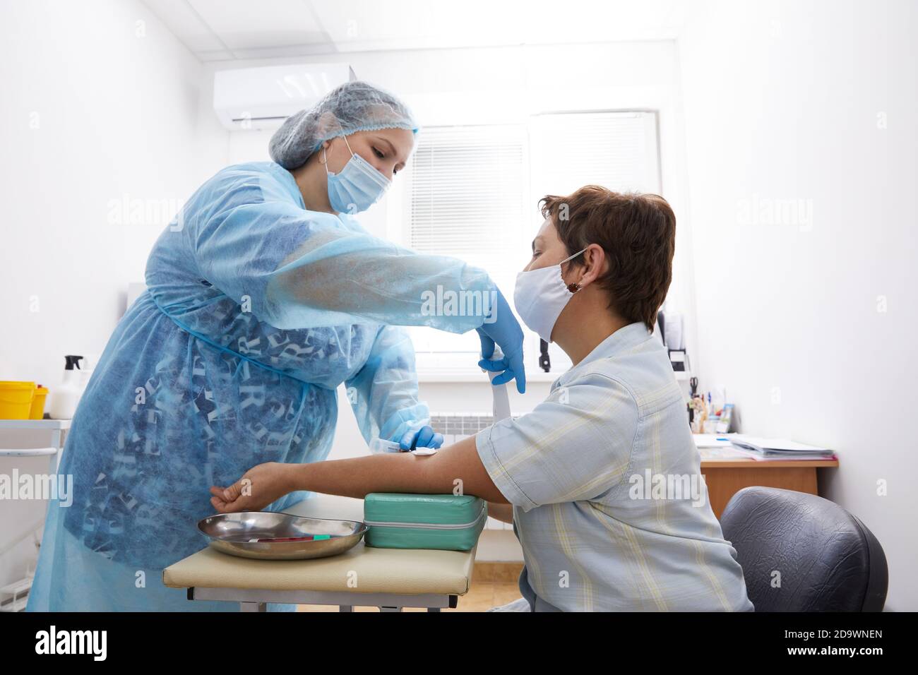 Woman giving blood sample doctor hi-res stock photography and images ...