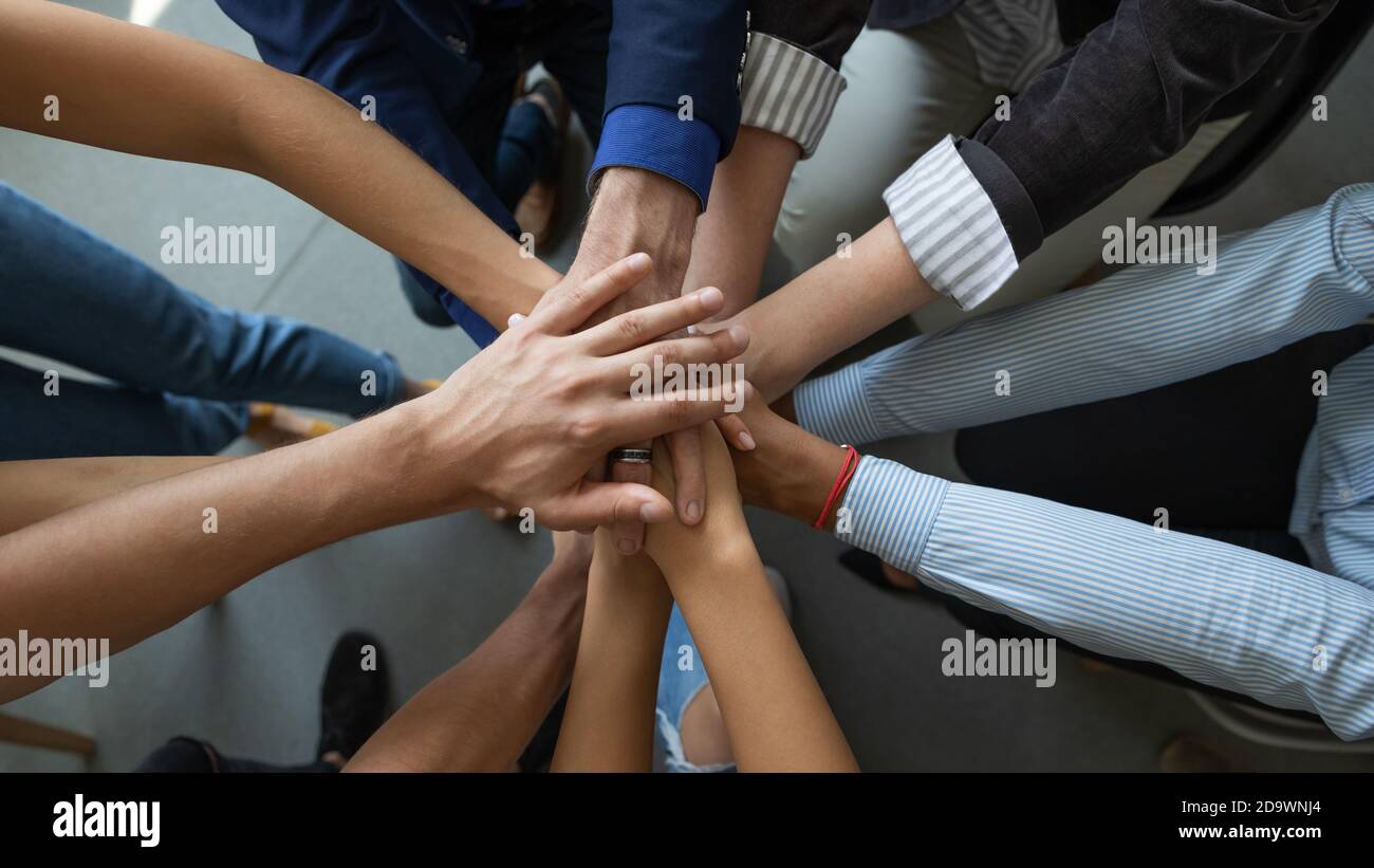 Diverse people business partners friends colleagues stacking palms in ...