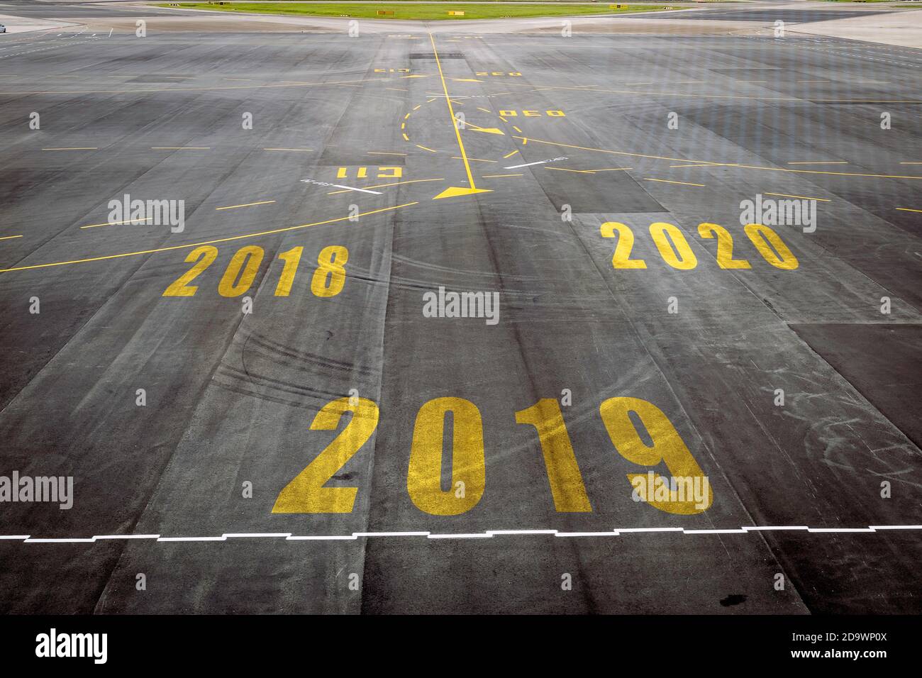 Closeup 2019 figures on the surface of the airport runway texture ...