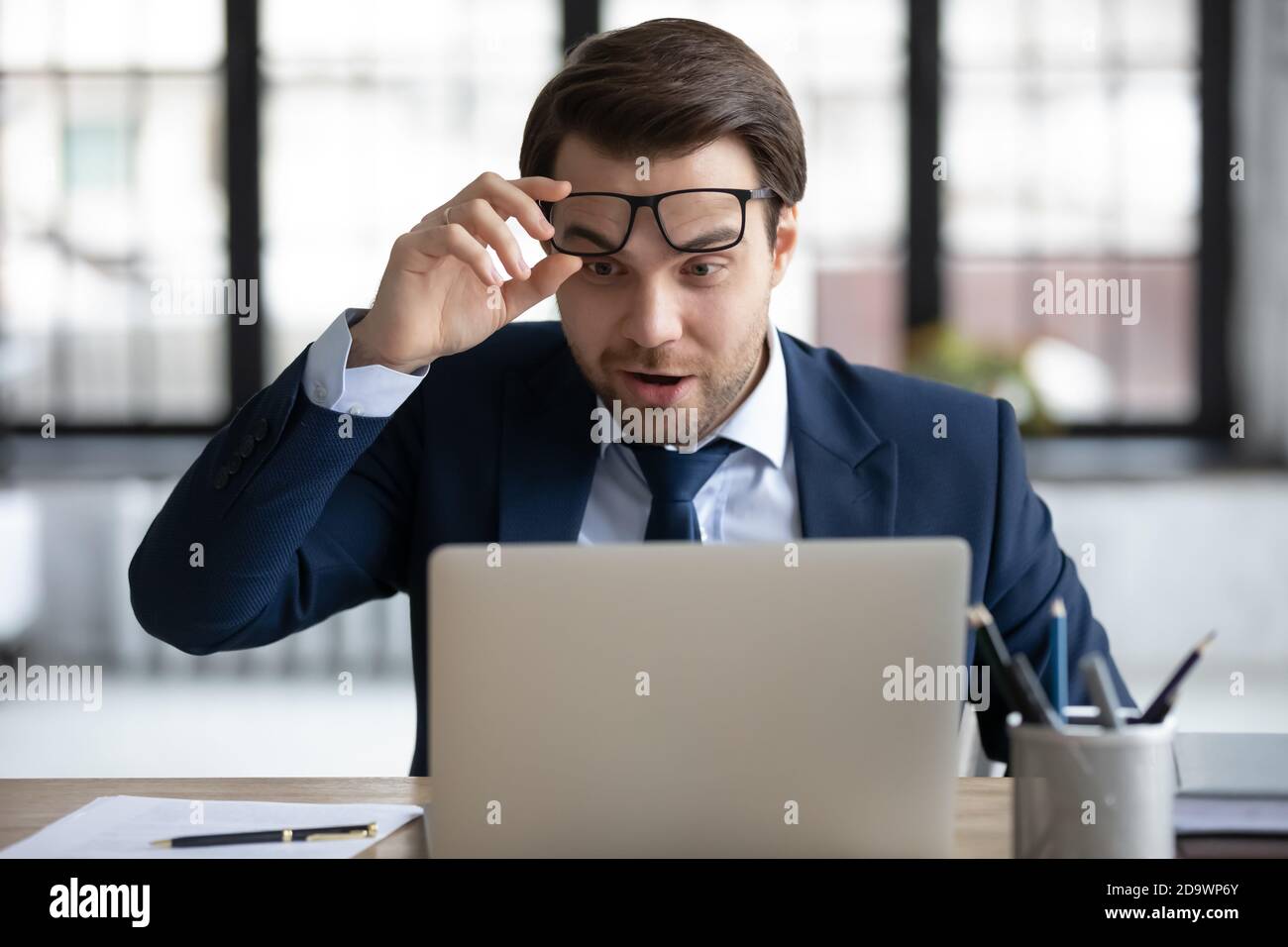 Surprised lucky 30s male employee received good news notification Stock ...