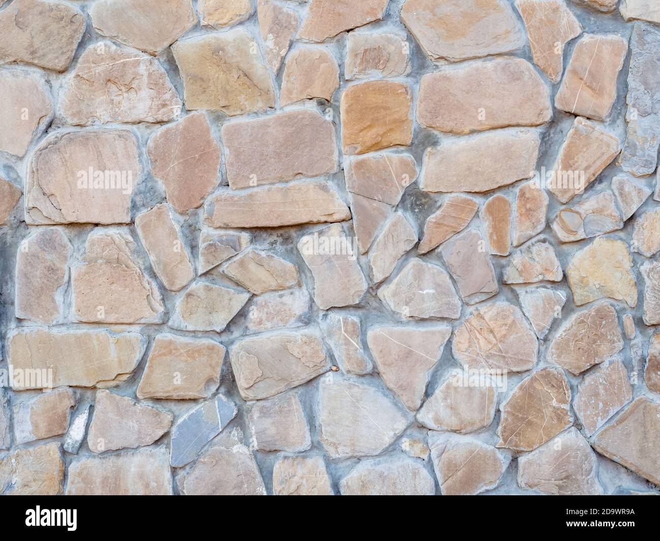 A wall with disorderly stonework. Background texture. Full screen Stock ...