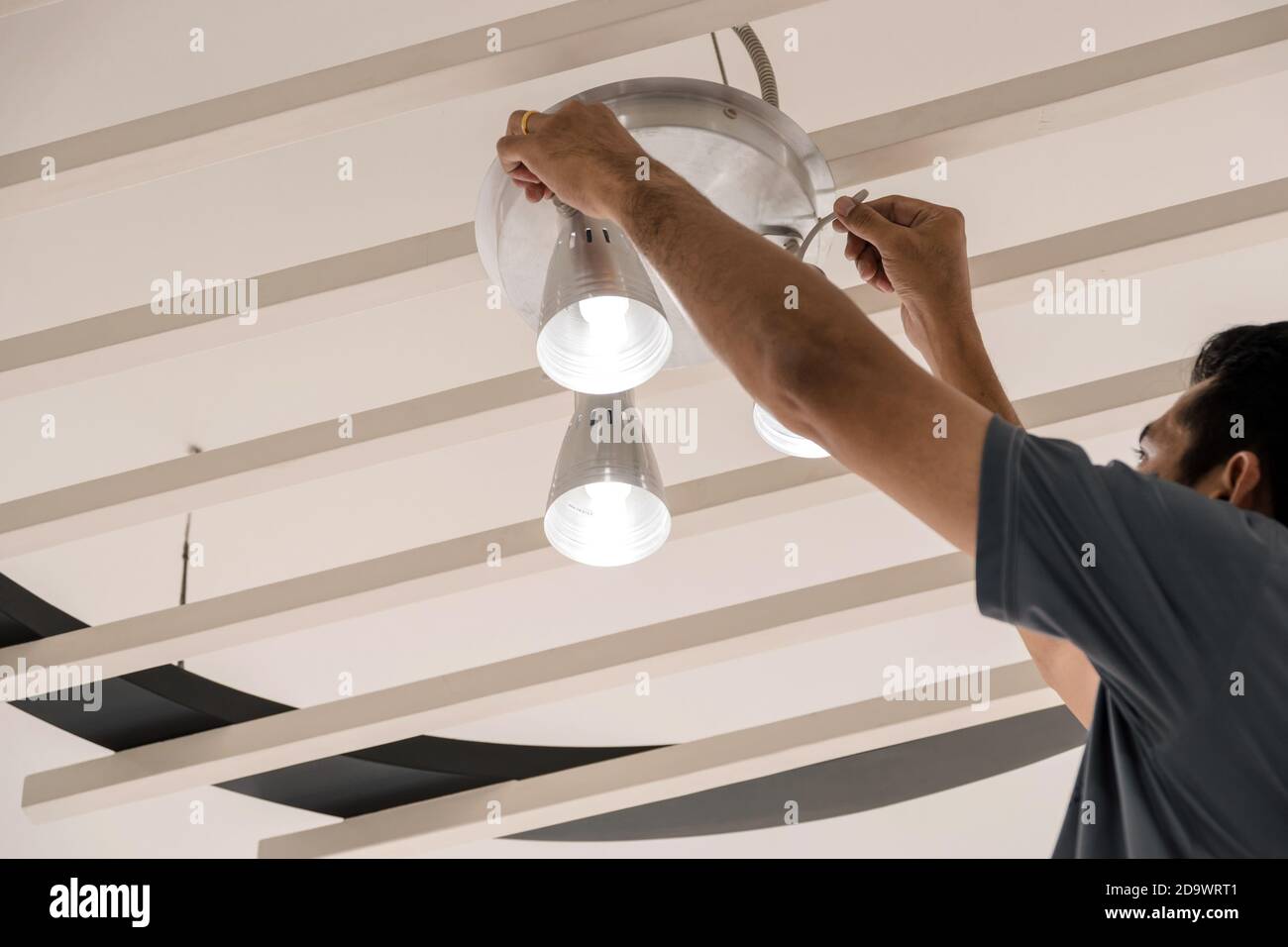 Electrical engineers are installing ceiling lamps in the hallway Stock ...