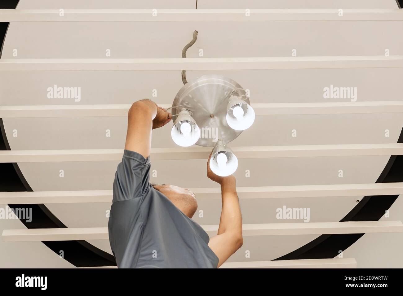 Electrical engineers are installing ceiling lamps in the hallway Stock ...