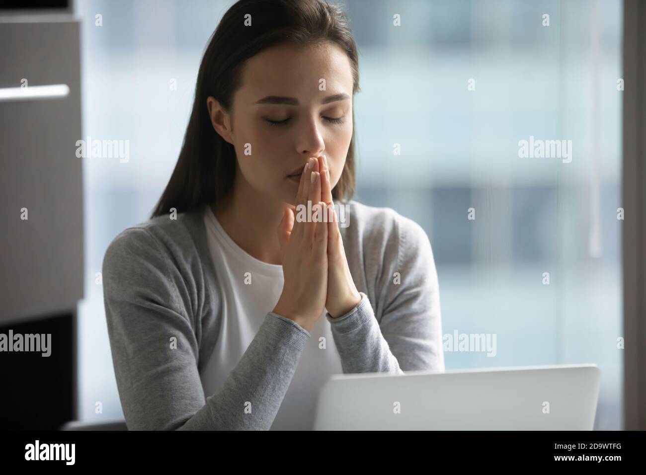 Worried female student praying for luck expecting test results Stock ...