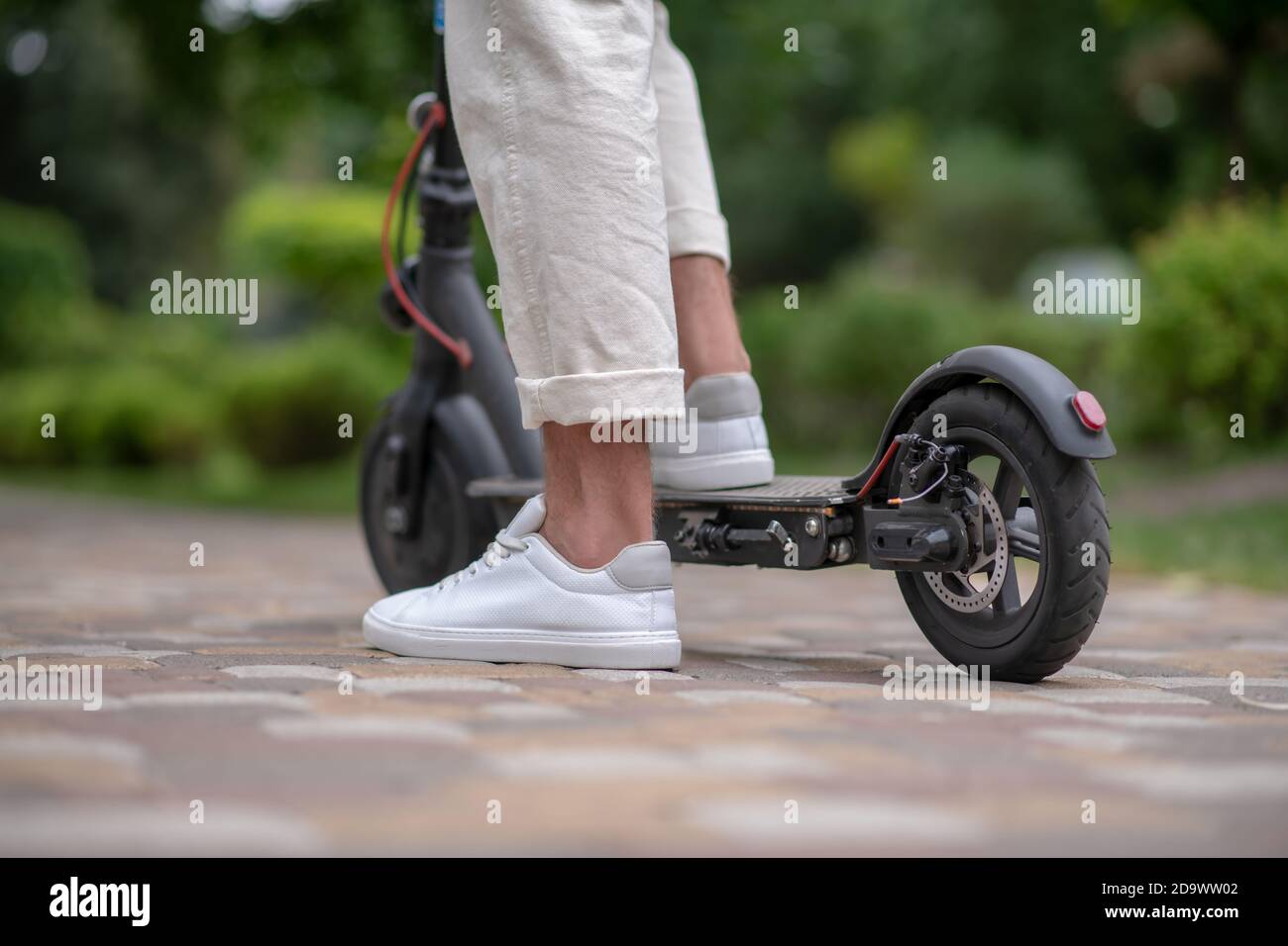 Scooter. Close up picture of human feet standing on a scooter Stock ...
