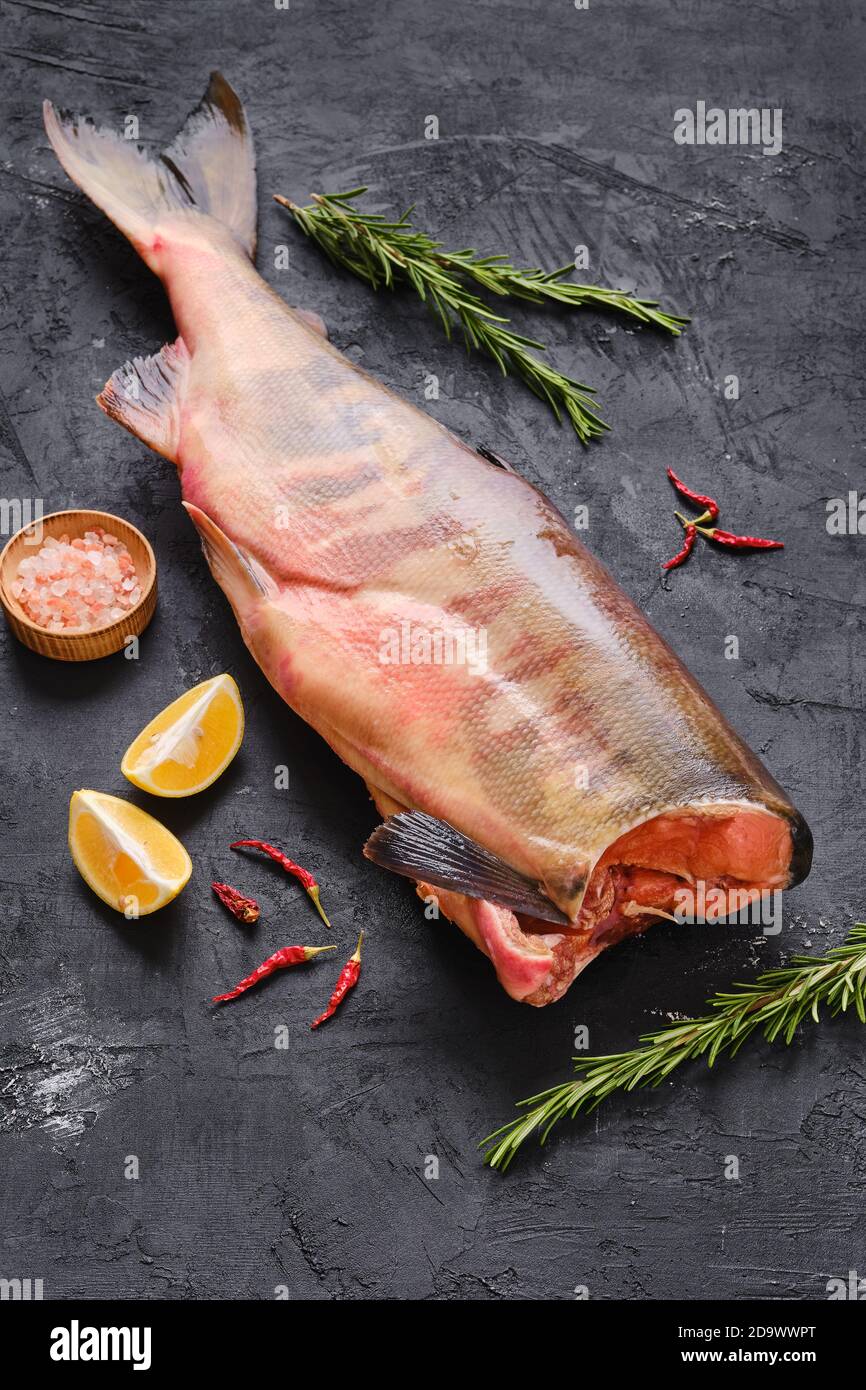Frozen raw headless chum fish on dark background Stock Photo - Alamy