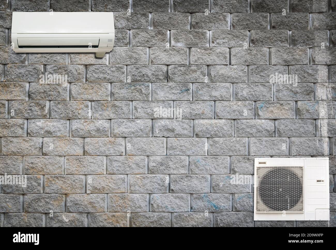 Wall air conditioning and compressor hanging on a brick wall Stock ...