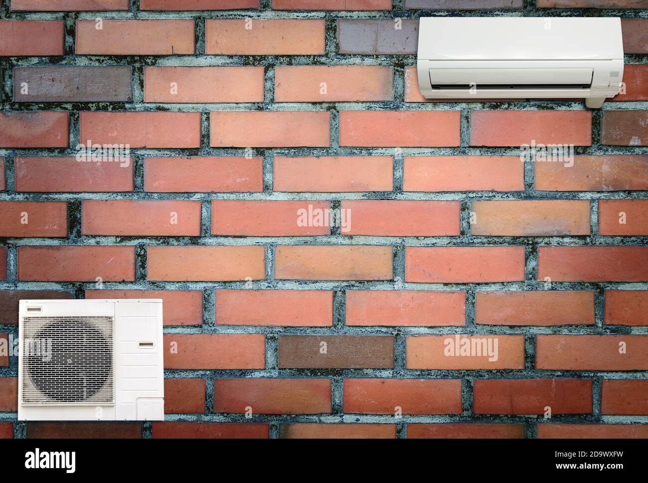 Wall air conditioning and compressor hanging on a brick wall Stock ...