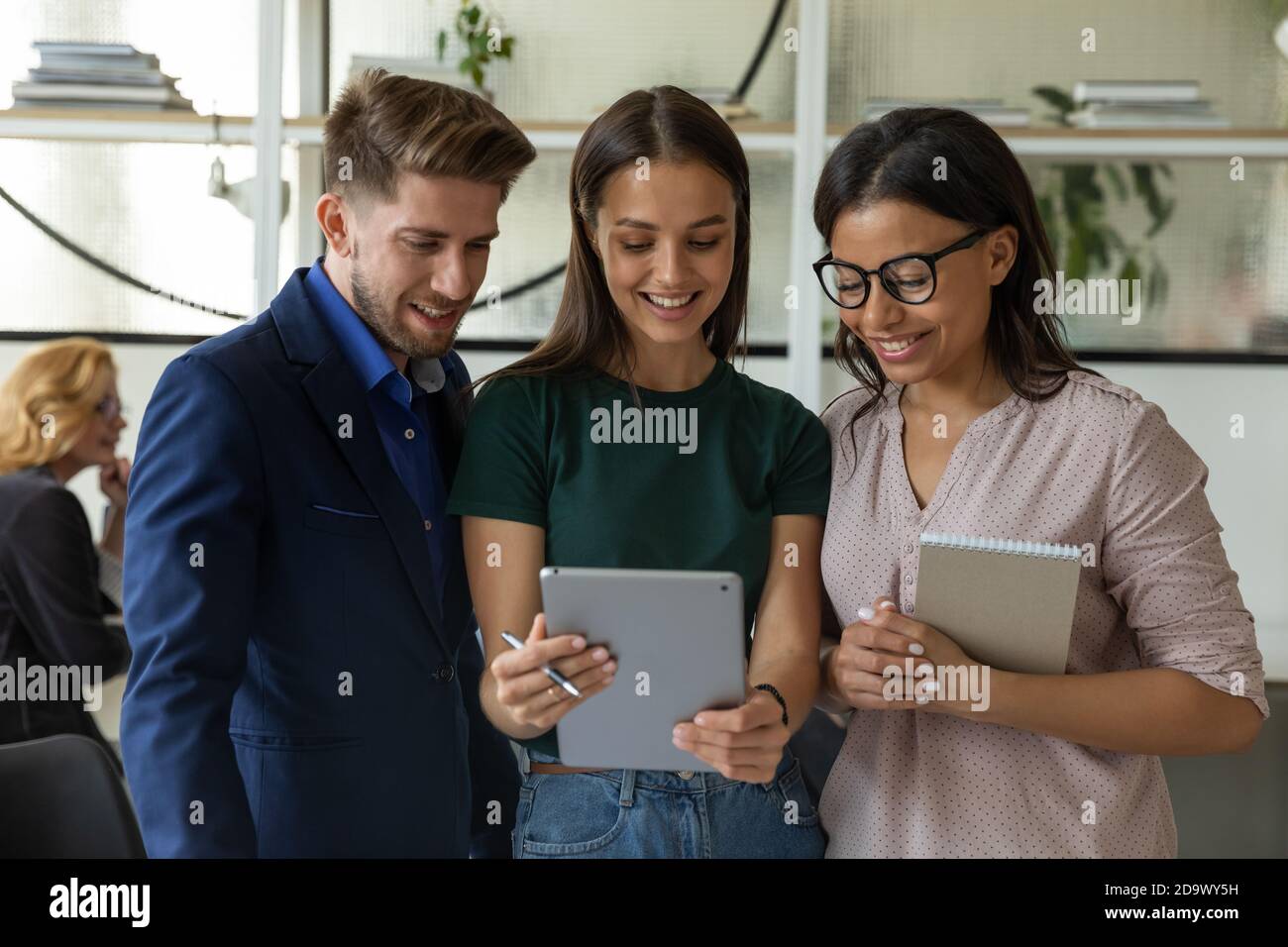 Diverse group of millennial coworkers having conversation at office ...