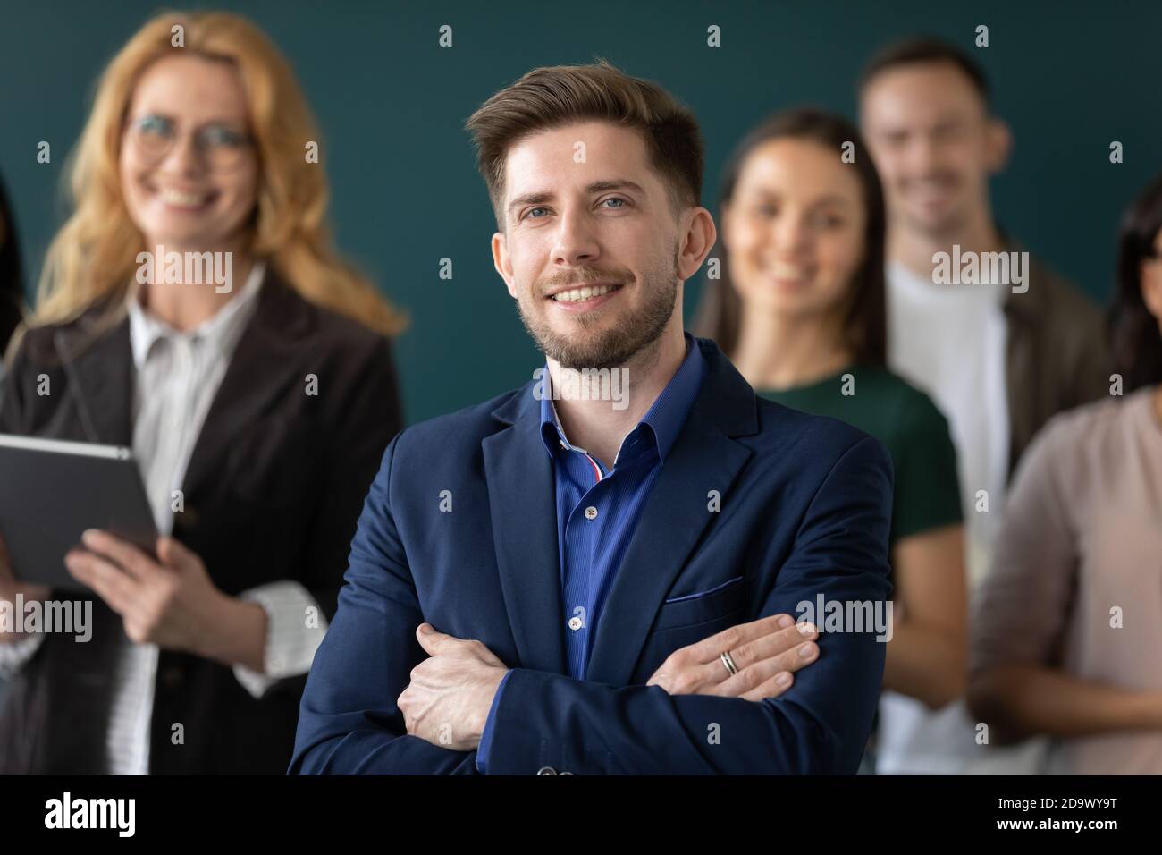 Friendly capable modern leader and diverse team posing for portrait ...