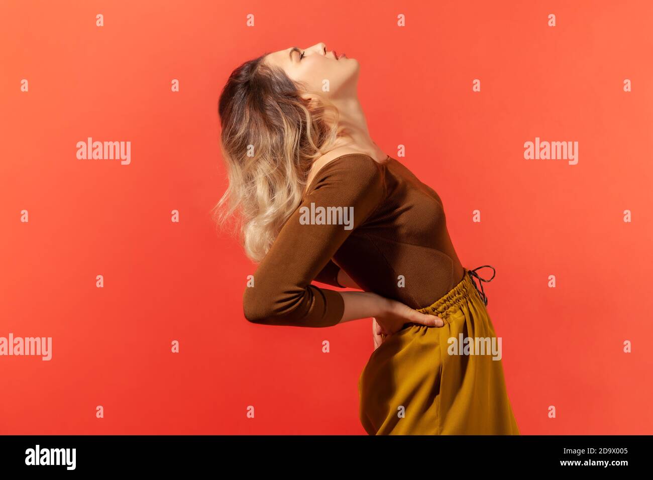 Backache. Side view portrait of unhealthy woman screaming in acute pain ...