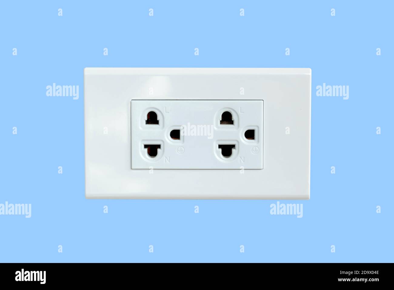 AC power plug isolated on blue background Stock Photo - Alamy